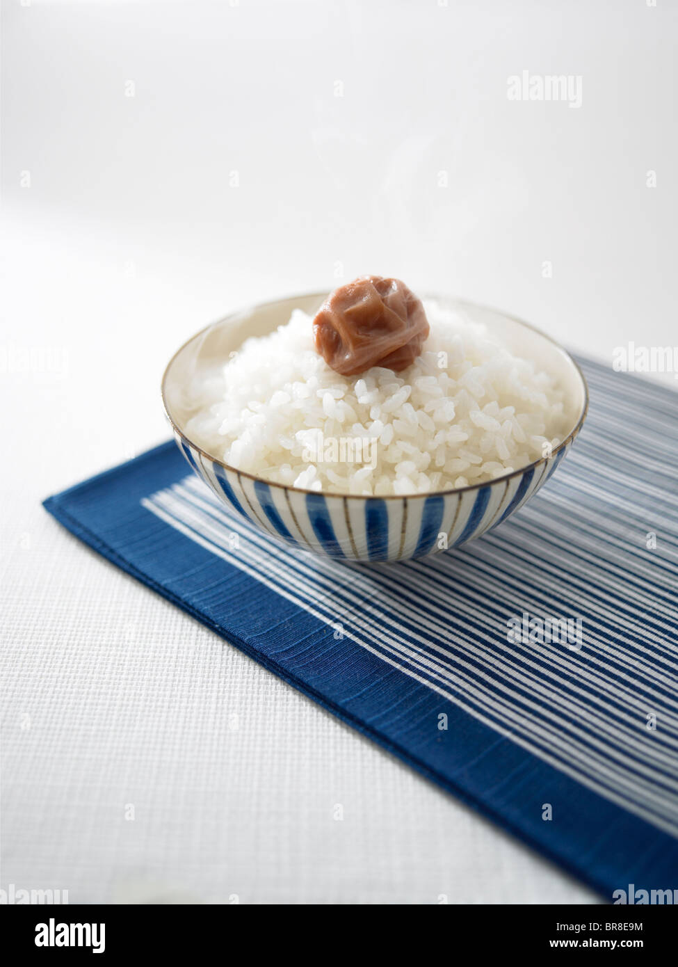 Steamed rice and pickled plum in a bowl Stock Photo - Alamy