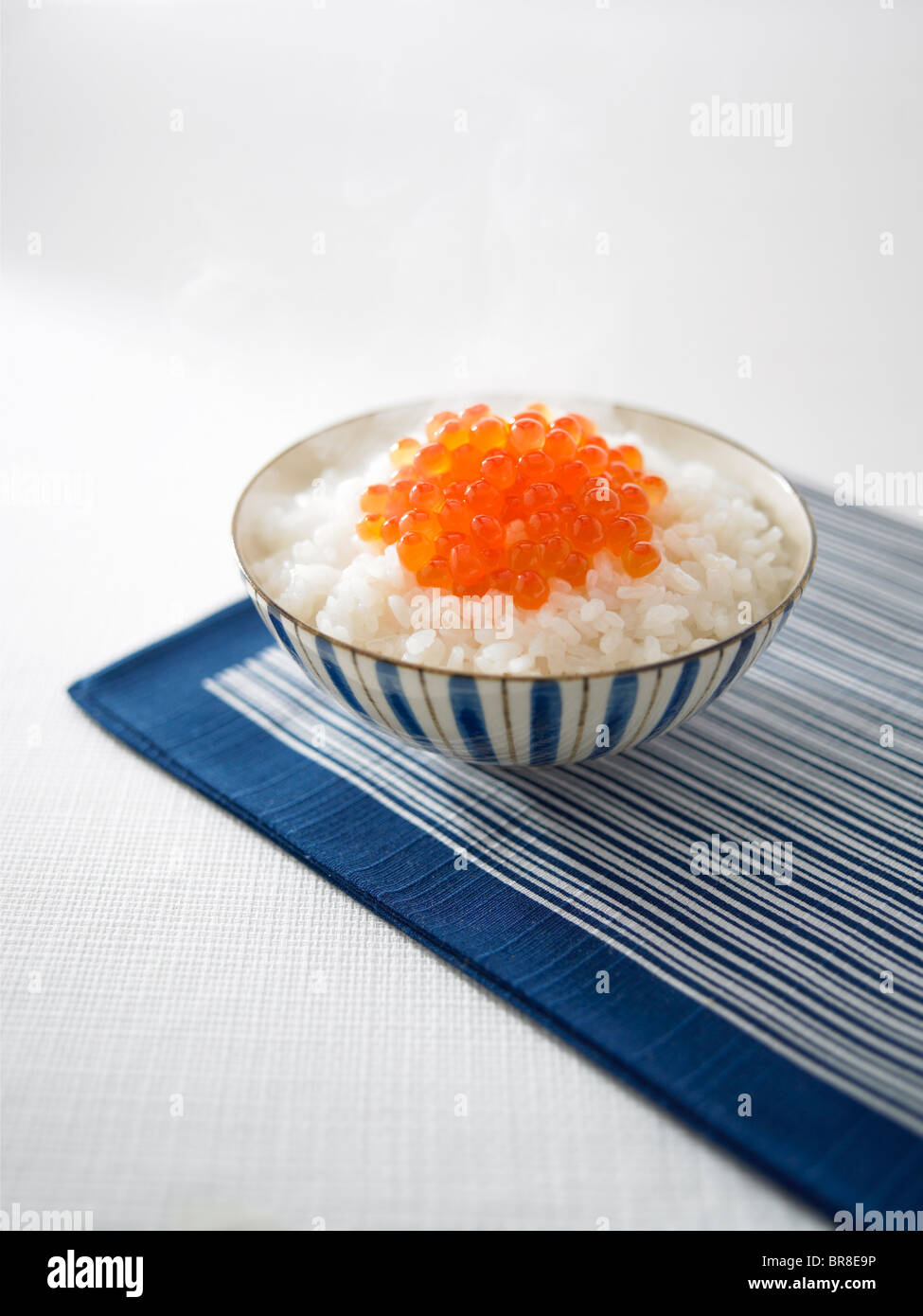 Bowl of rice with salmon roe, white background Stock Photo - Alamy