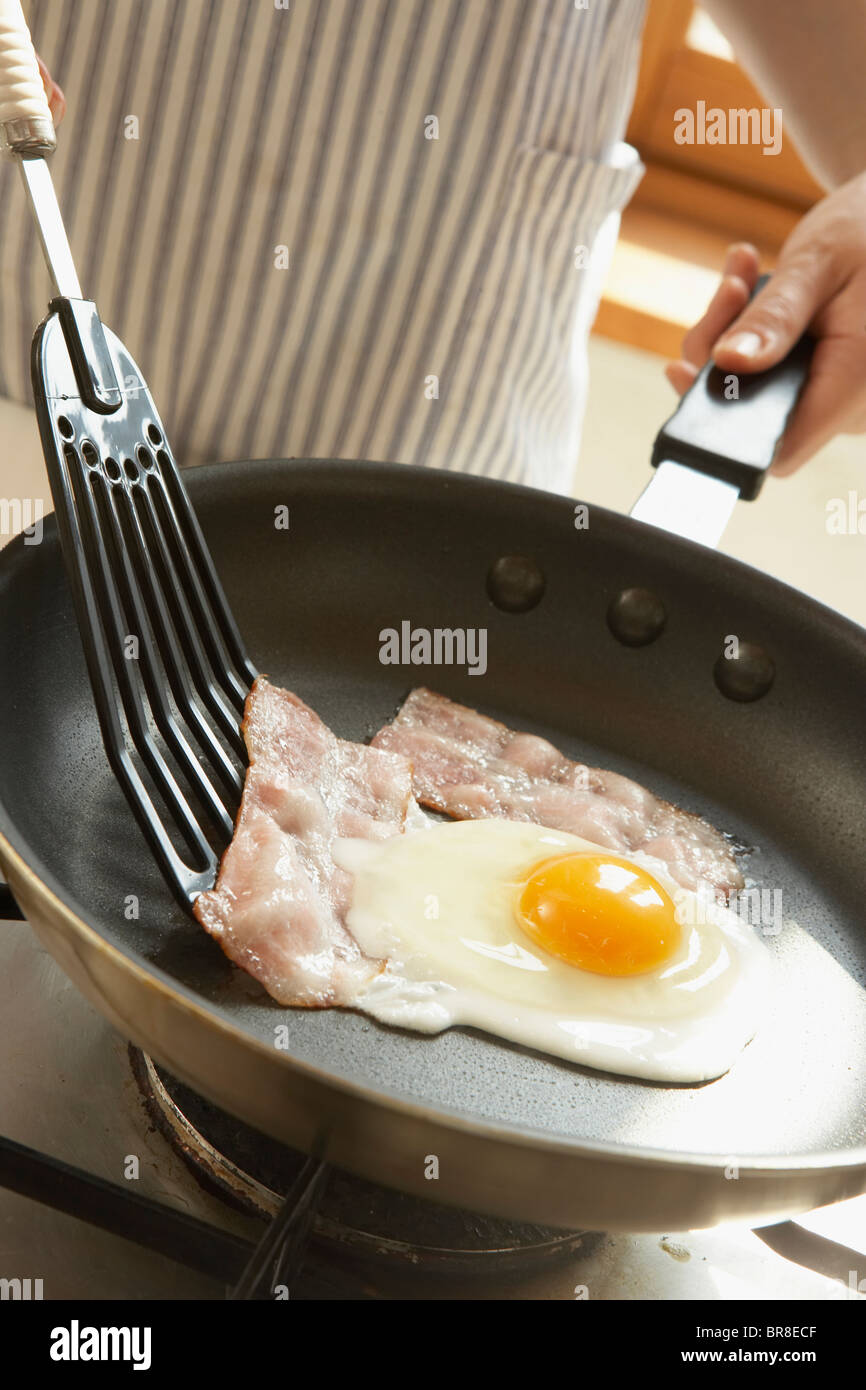 Woman frying bacon hi-res stock photography and images - Alamy