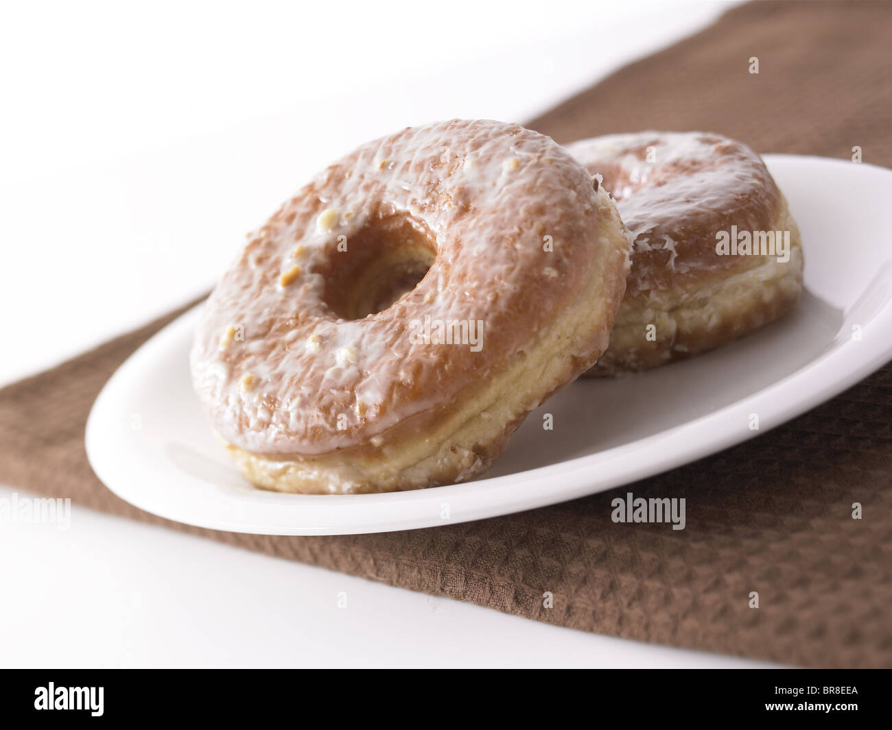 Doughnuts on plate, close up, white background Stock Photo - Alamy