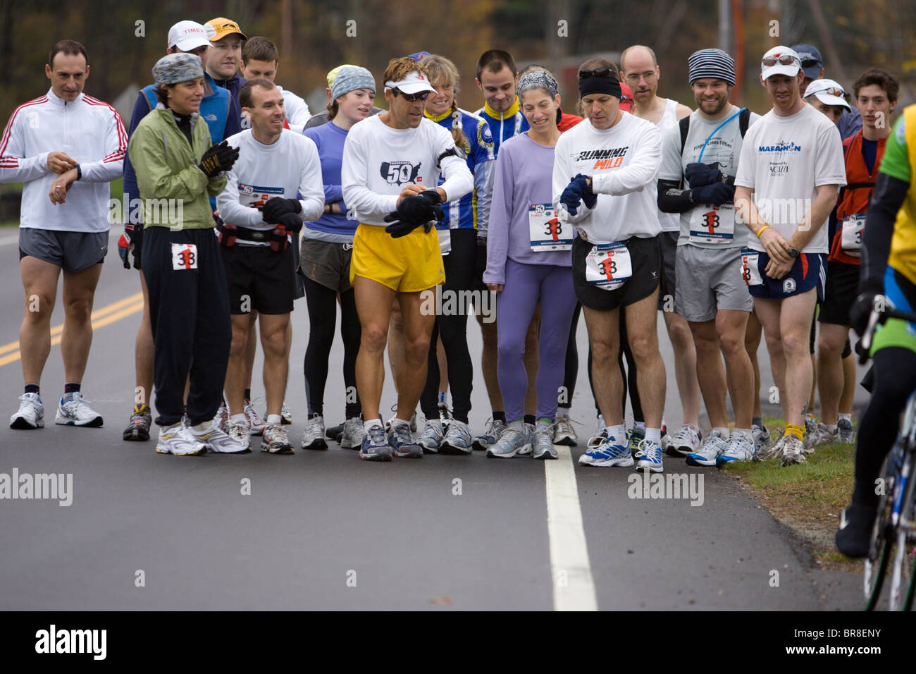 Marathon runners checking their watches at the start of a race in Stowe ...