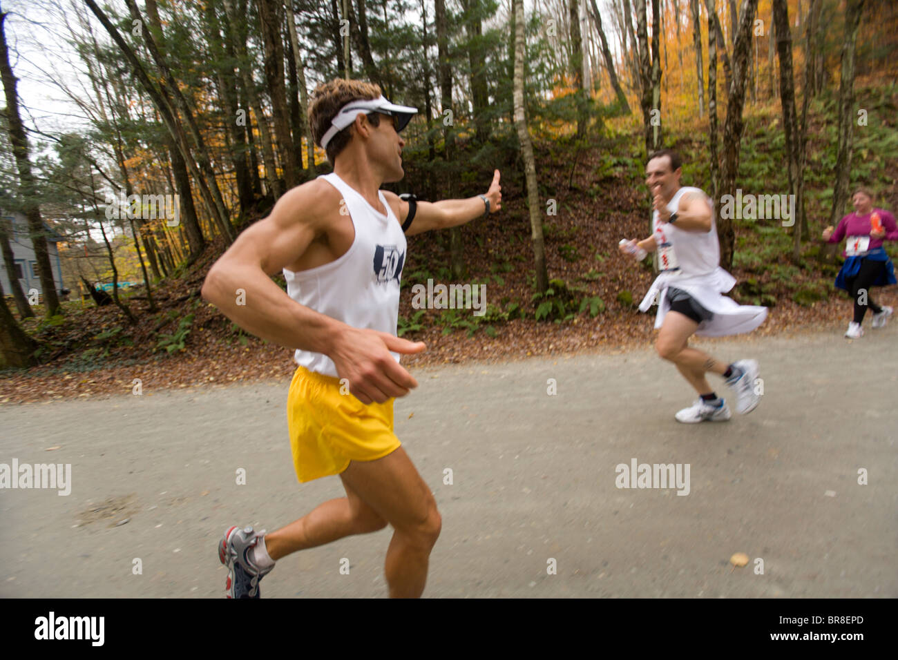 Runner giving another runner a high five during a marathon in Stowe ...