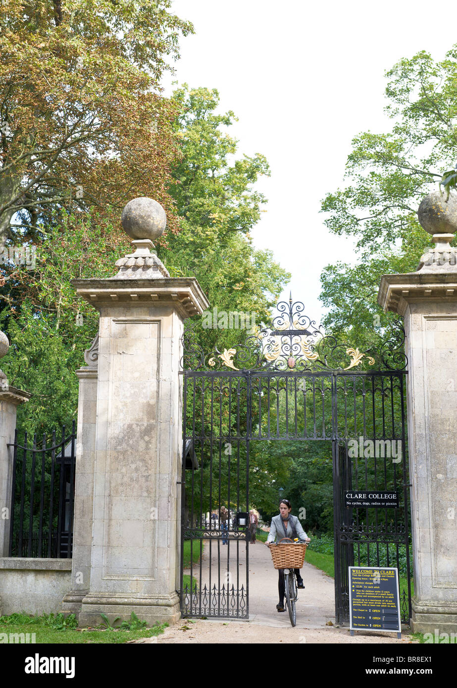 Cyclist coming out back entrance of Clare college, Cambridge university ...