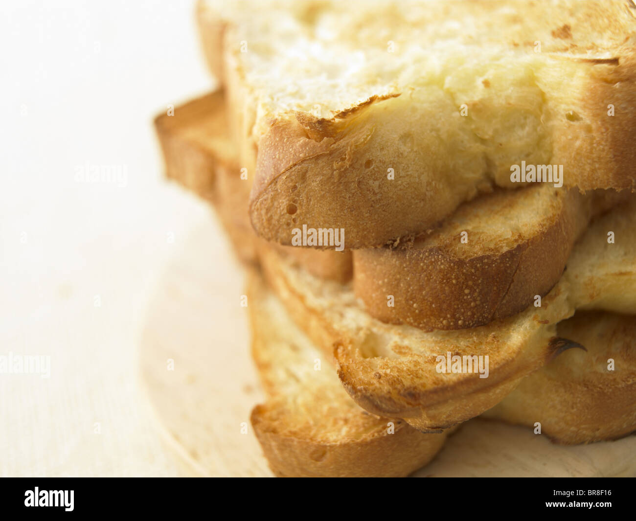 Pile of toast on cutting board, close up, white background Stock Photo ...