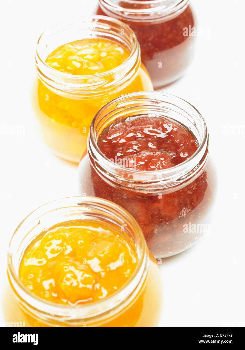 Four jars of jam, close up, white background Stock Photo - Alamy