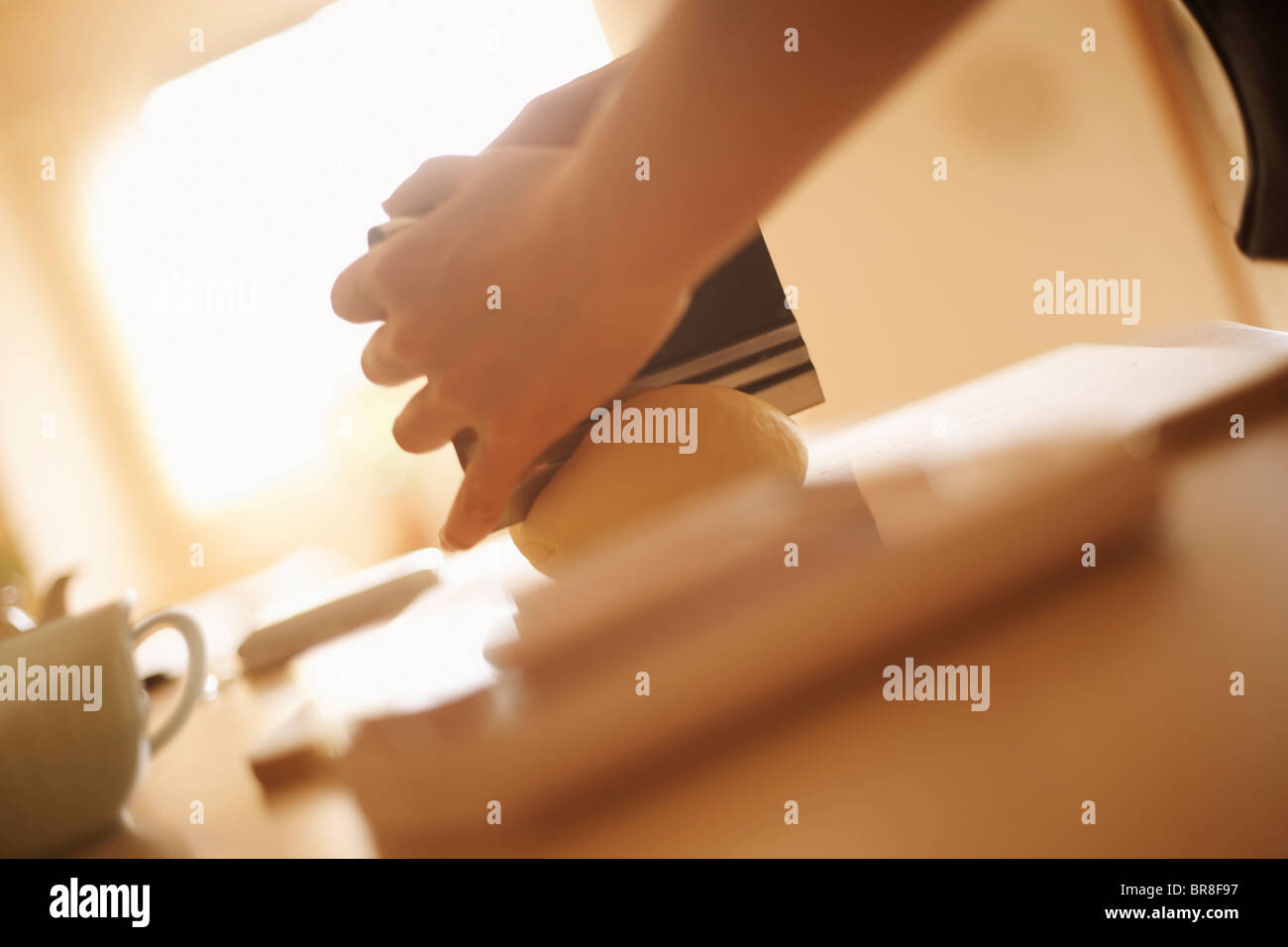 Woman making bagels, cutting dough, close up Stock Photo - Alamy