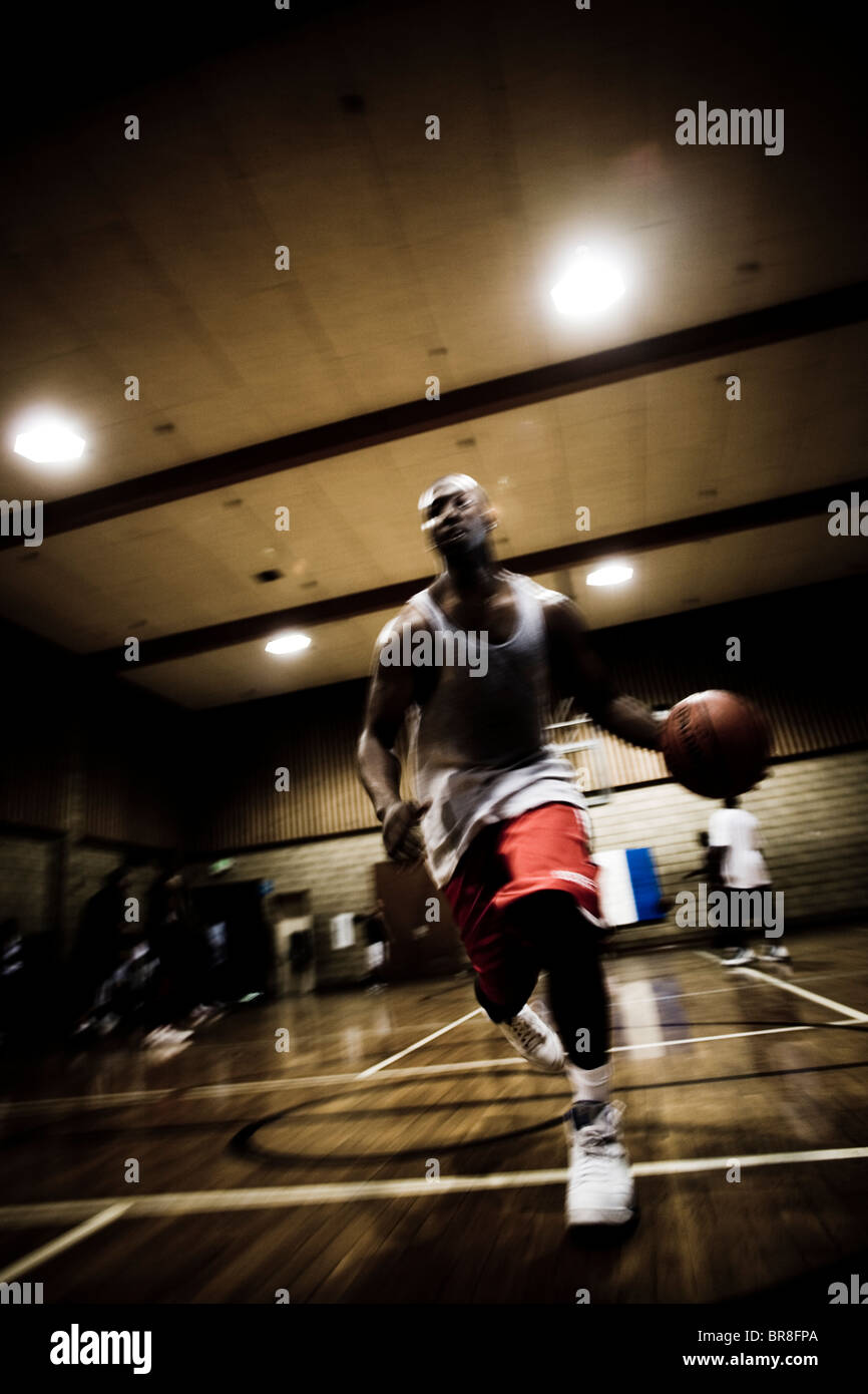 Group of guys playing basketball at an innercity gym Stock Photo - Alamy