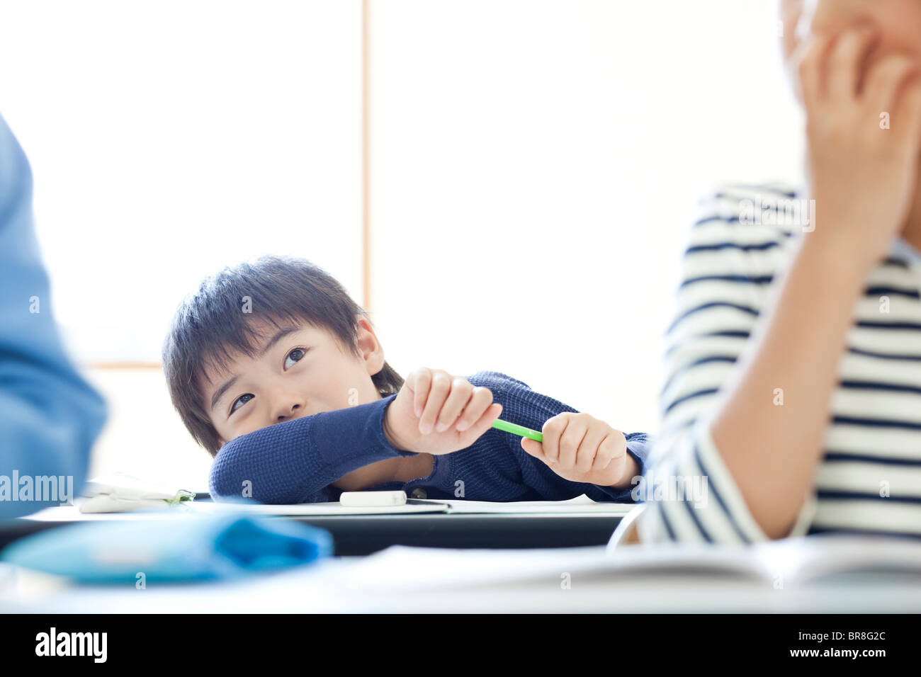 Boy thinking holding a pencil Stock Photo - Alamy