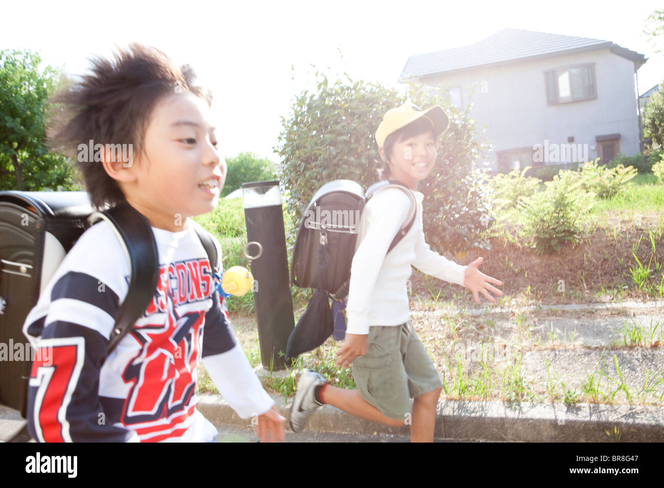 Elementary school students running to school Stock Photo - Alamy