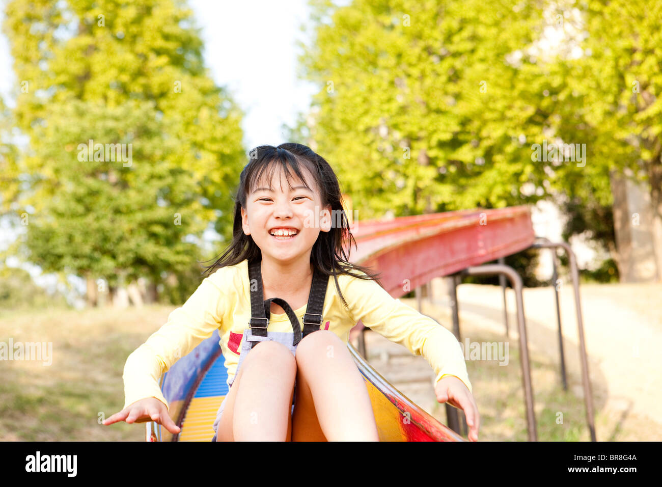 Child going down playground slide hi-res stock photography and images ...