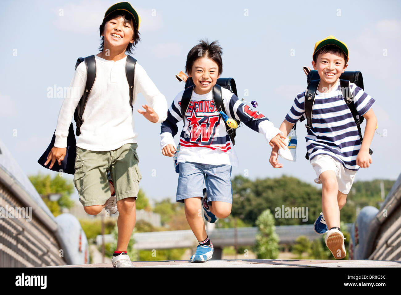 Elementary school students running to school Stock Photo - Alamy