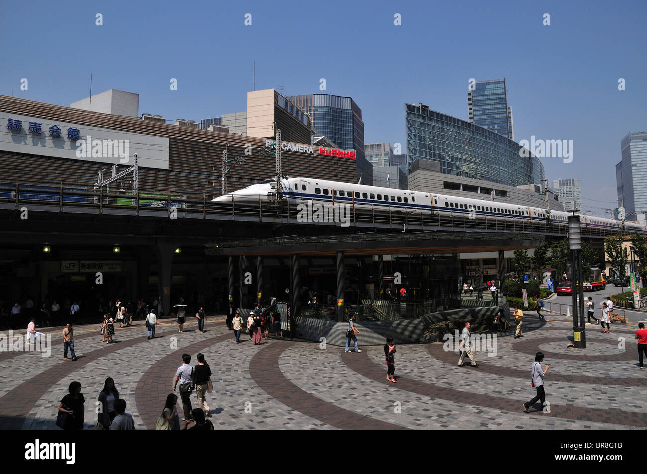 Bullet train running in city Stock Photo - Alamy