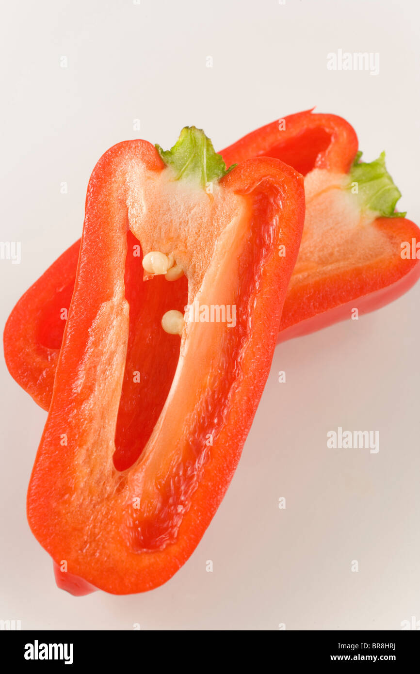 Red bell pepper cut in half, close up, white background Stock Photo - Alamy