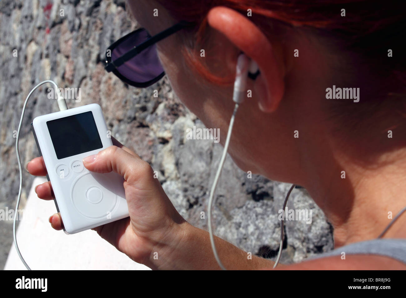 Redheaded woman using an Ipod Stock Photo - Alamy