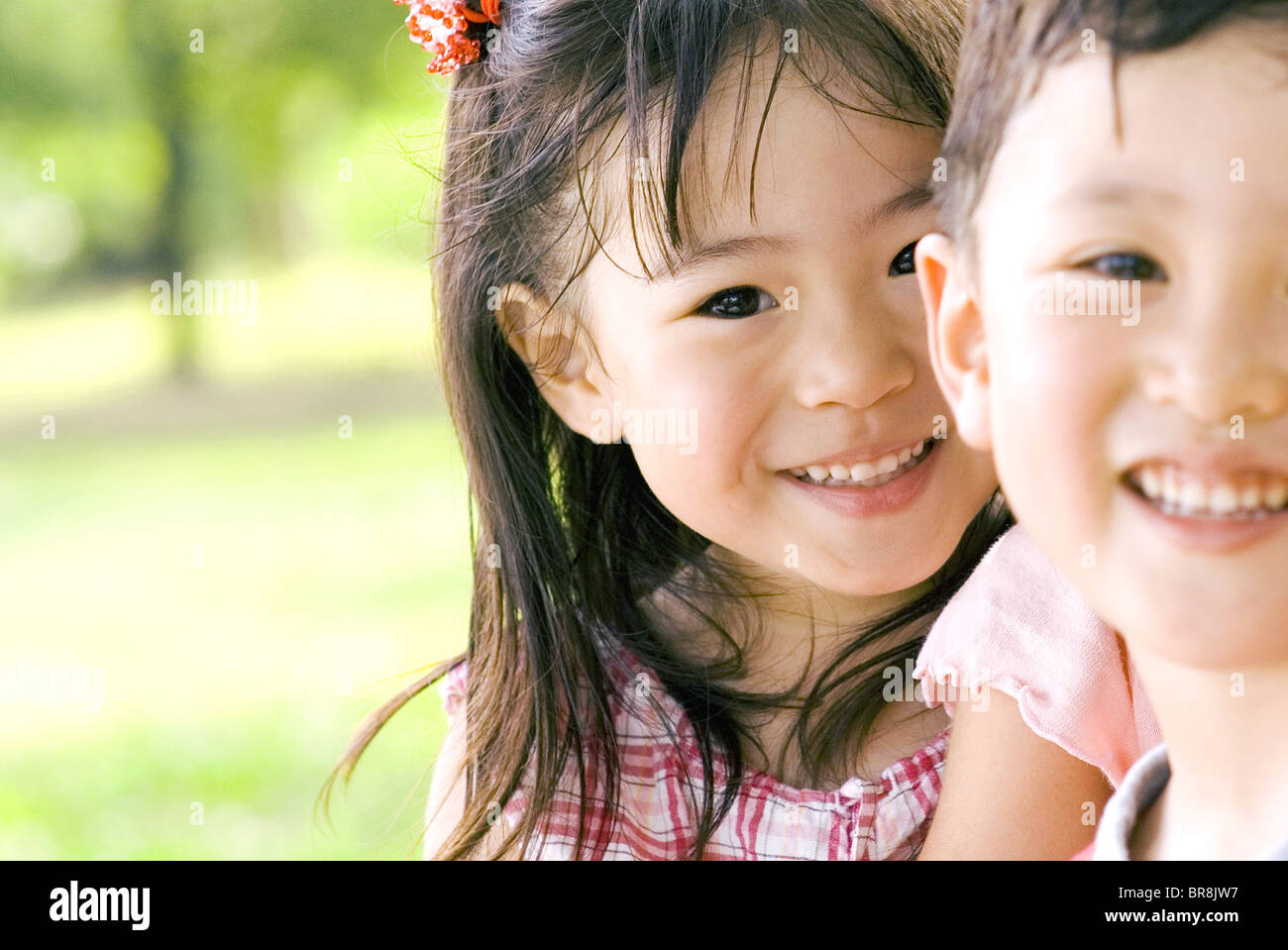 Girl and boy smiling outdoors Stock Photo - Alamy