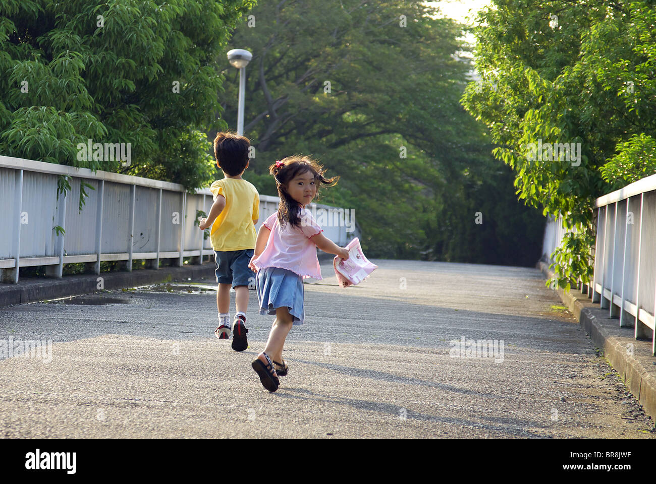Boy and girl running, rear view Stock Photo - Alamy