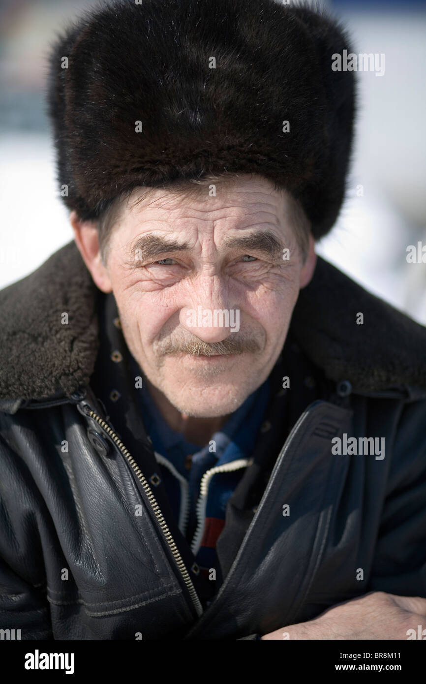 A portrait of a local man in the town center during the winter in ...