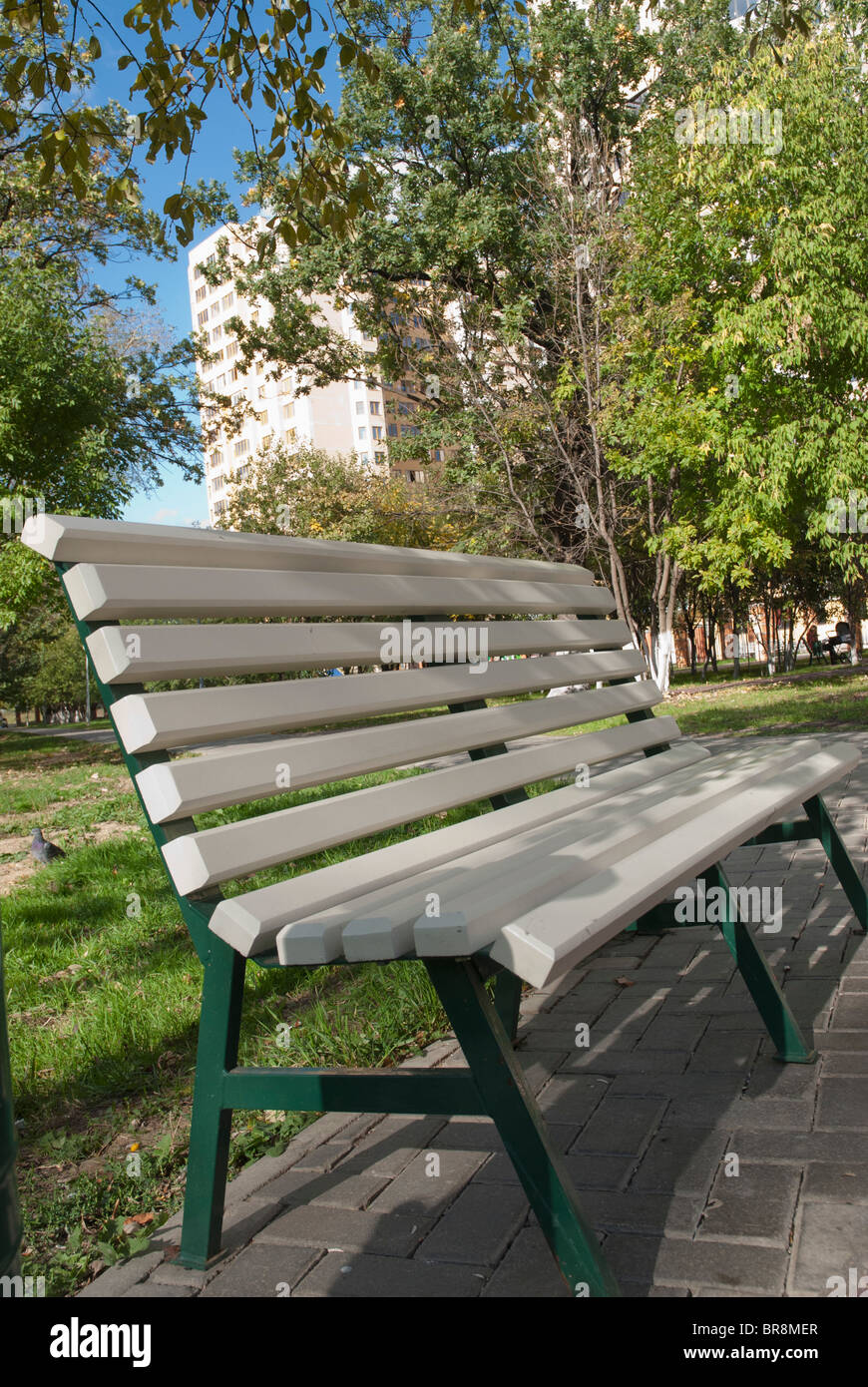 Bench in city park Stock Photo - Alamy
