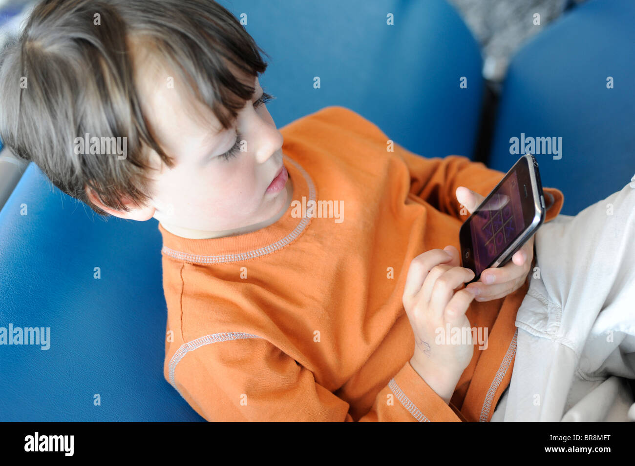 Child playing on iphone hi-res stock photography and images - Alamy