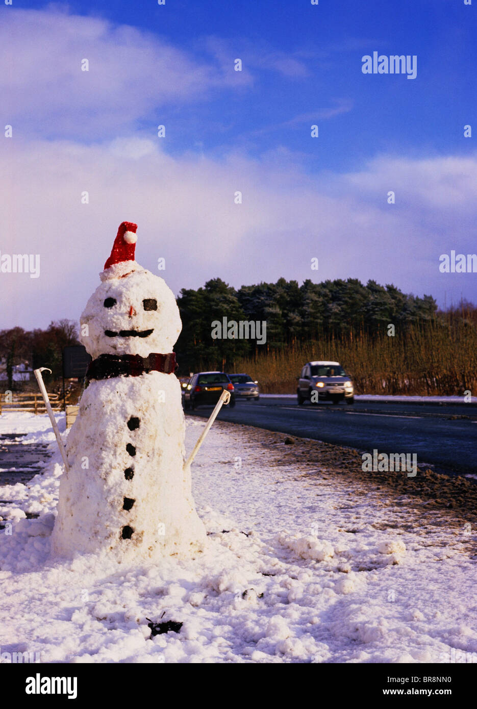 lorry passing roadside snowman on A64 near York in heavy winter snow UK ...