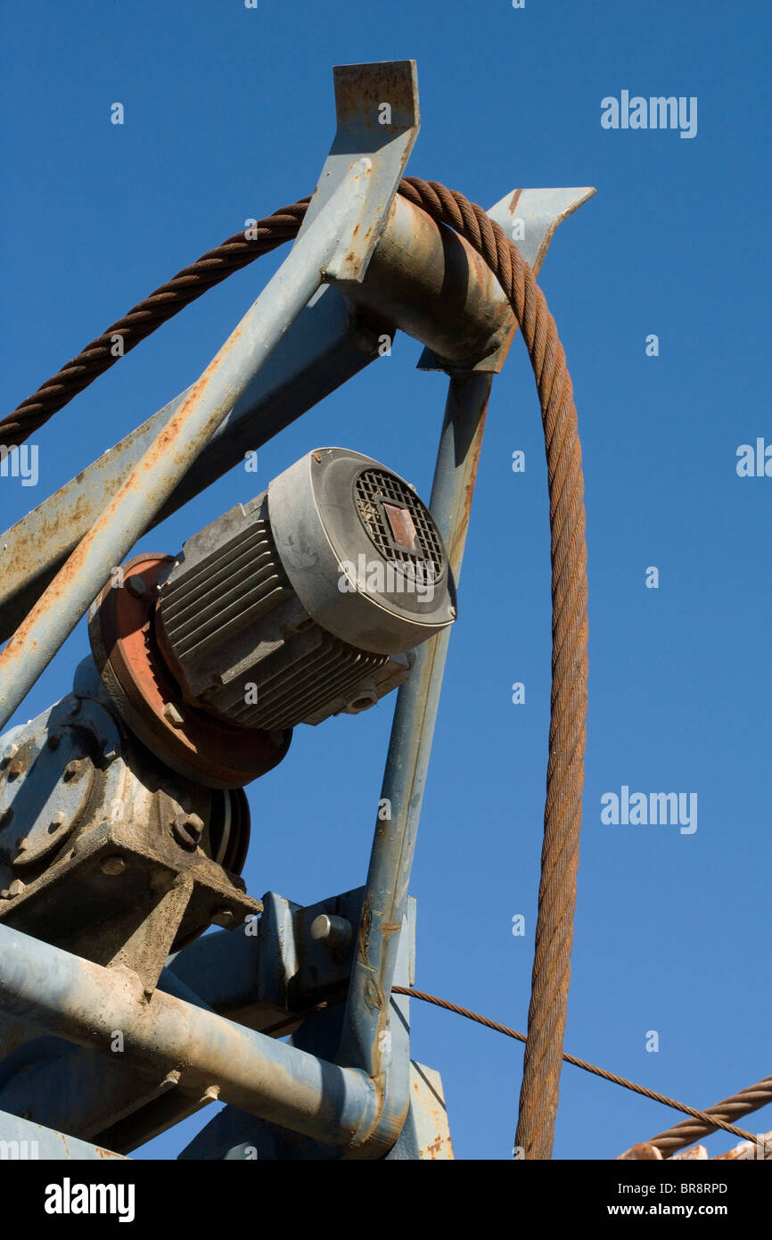 rusted bend steel cable rusting on top of a steel frame with an old ...