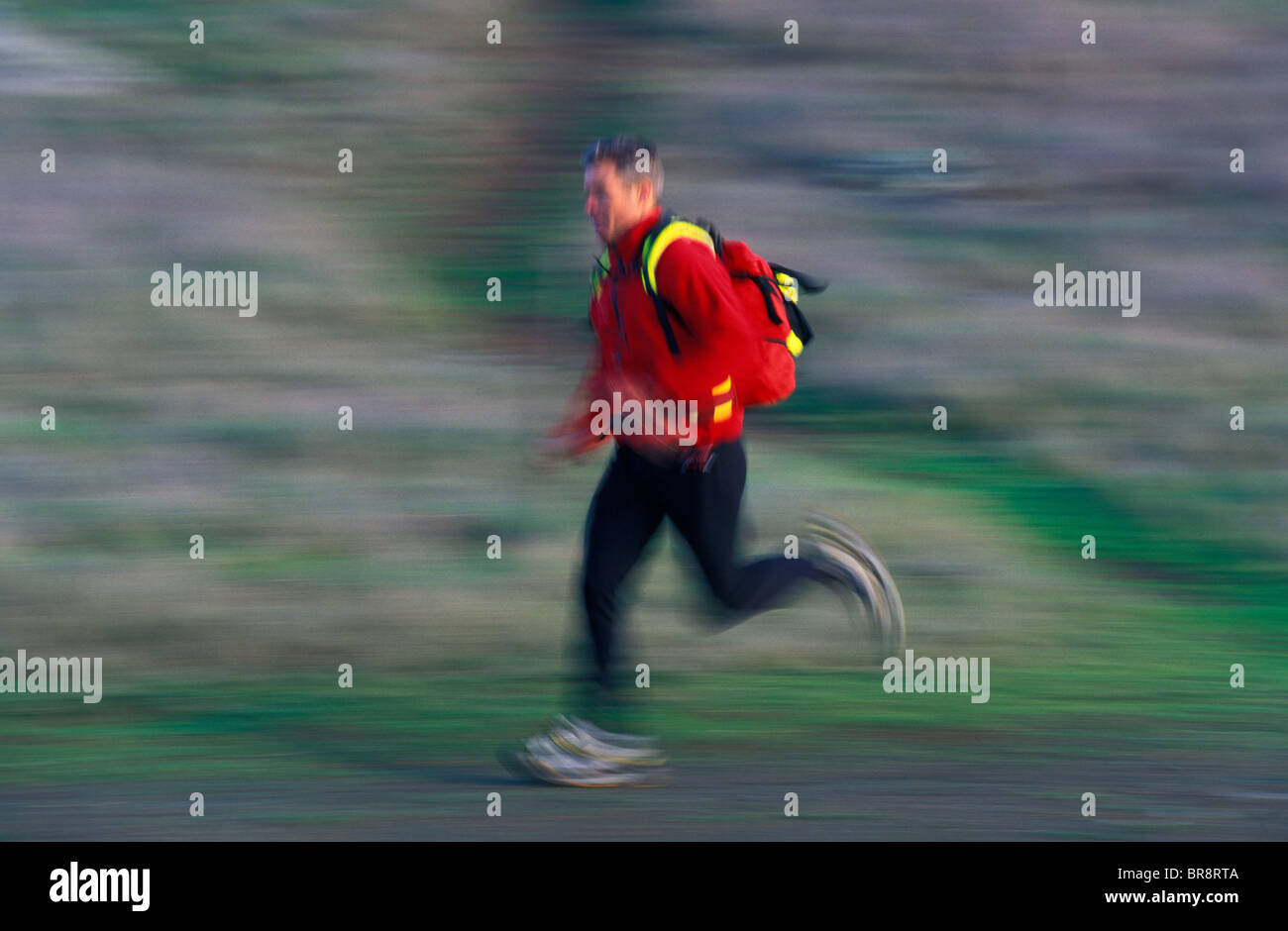 Man trail running in green hills (Motion Blur Stock Photo - Alamy