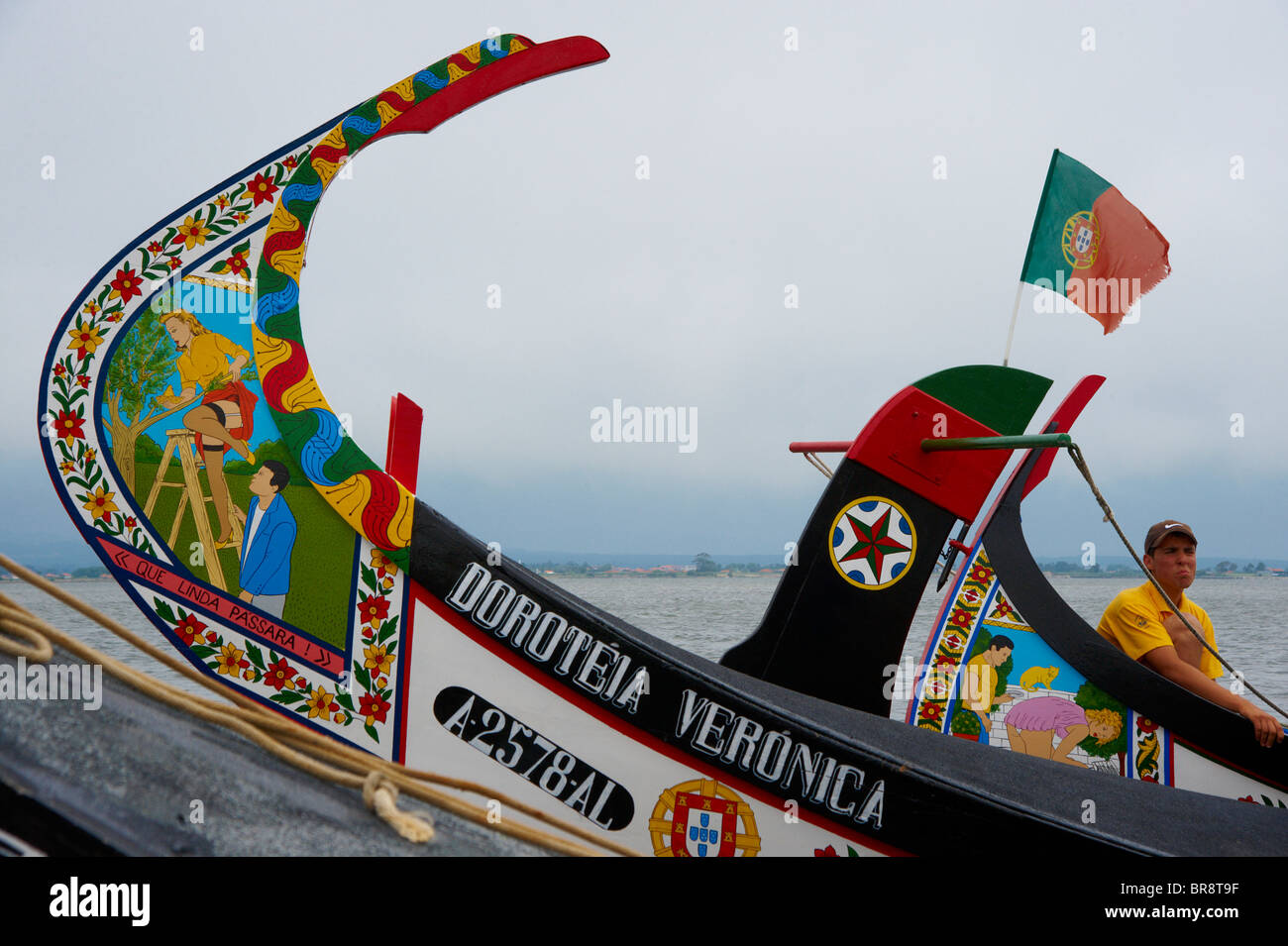 Teenager siting in a traditional Moliceiro boat in the Aveiro lagoon ...