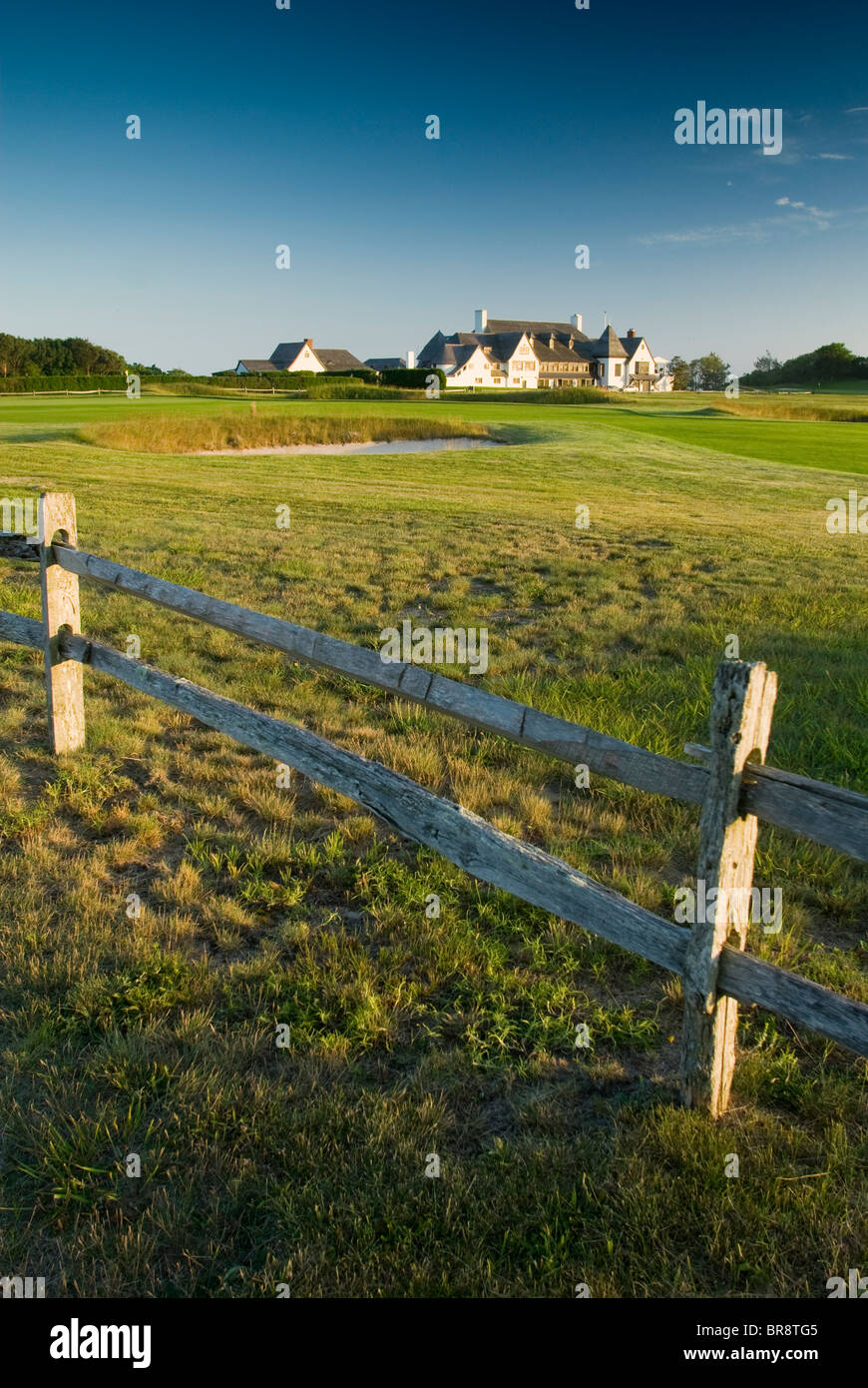 A golf club and fence border an exclusive country club in East Hampton ...