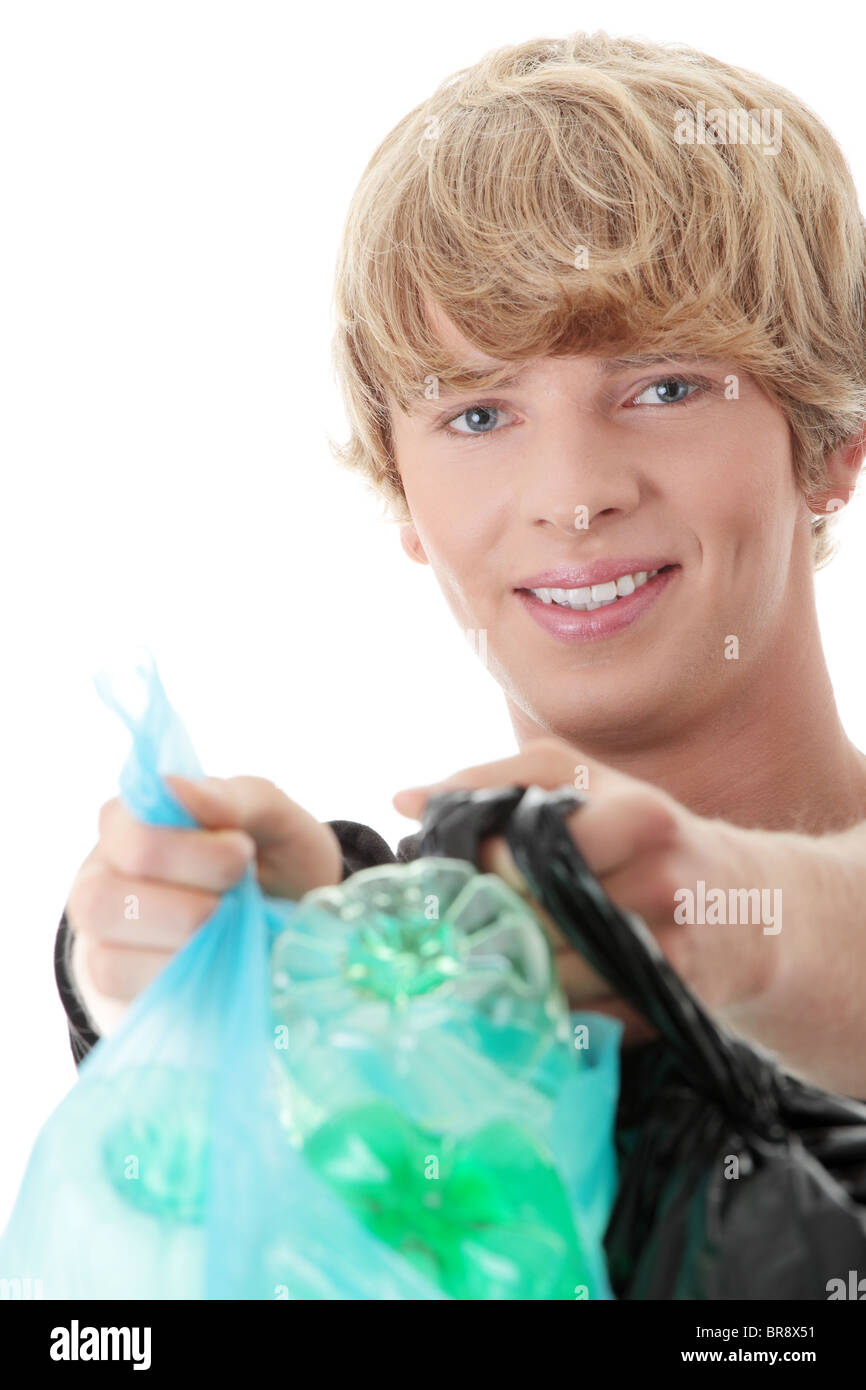 Young man carrying a plastic trash bags full with empty recyclable ...