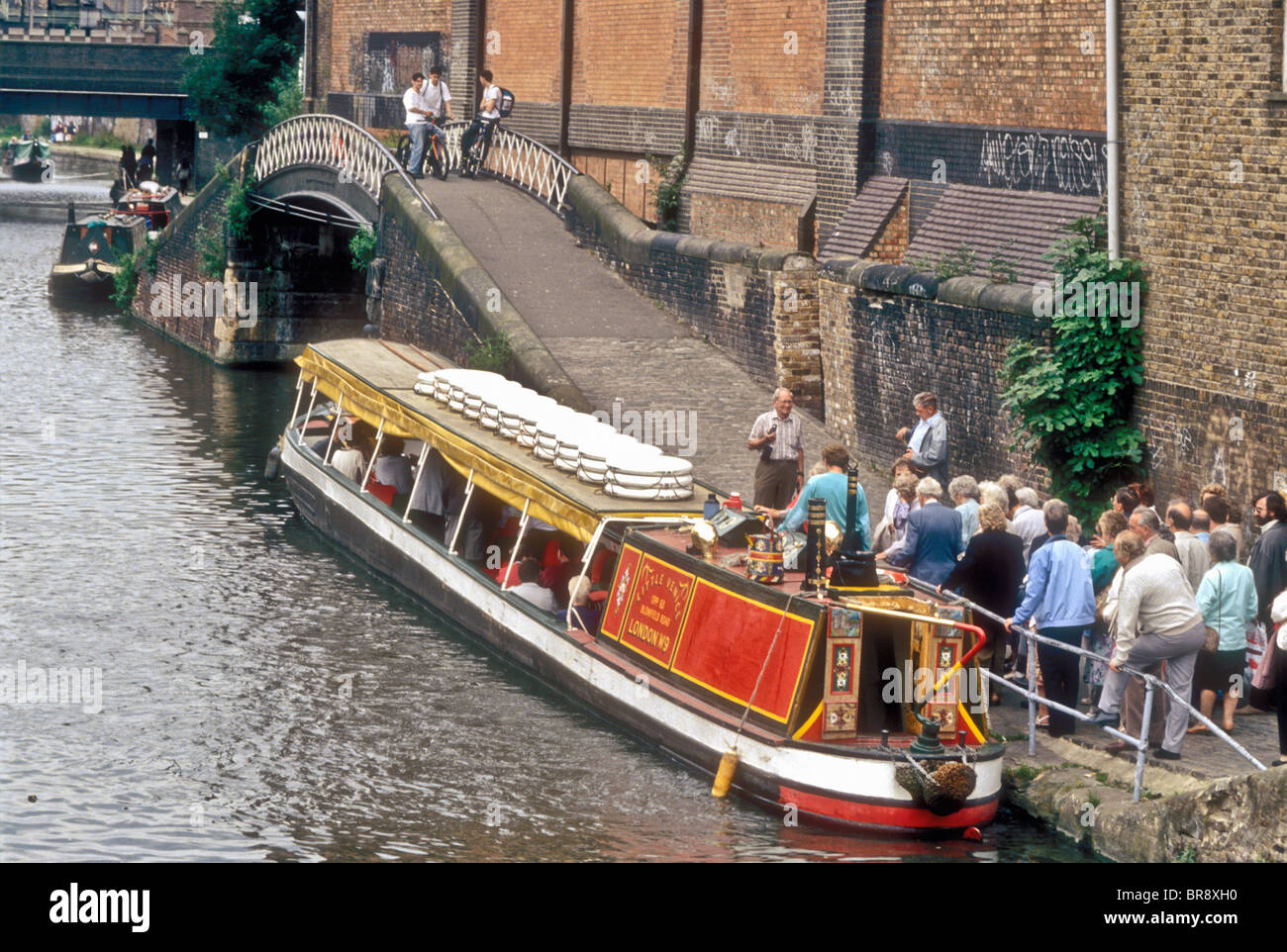 Passengers boarding a trip narrowboat on the Regents Canal at Camden ...
