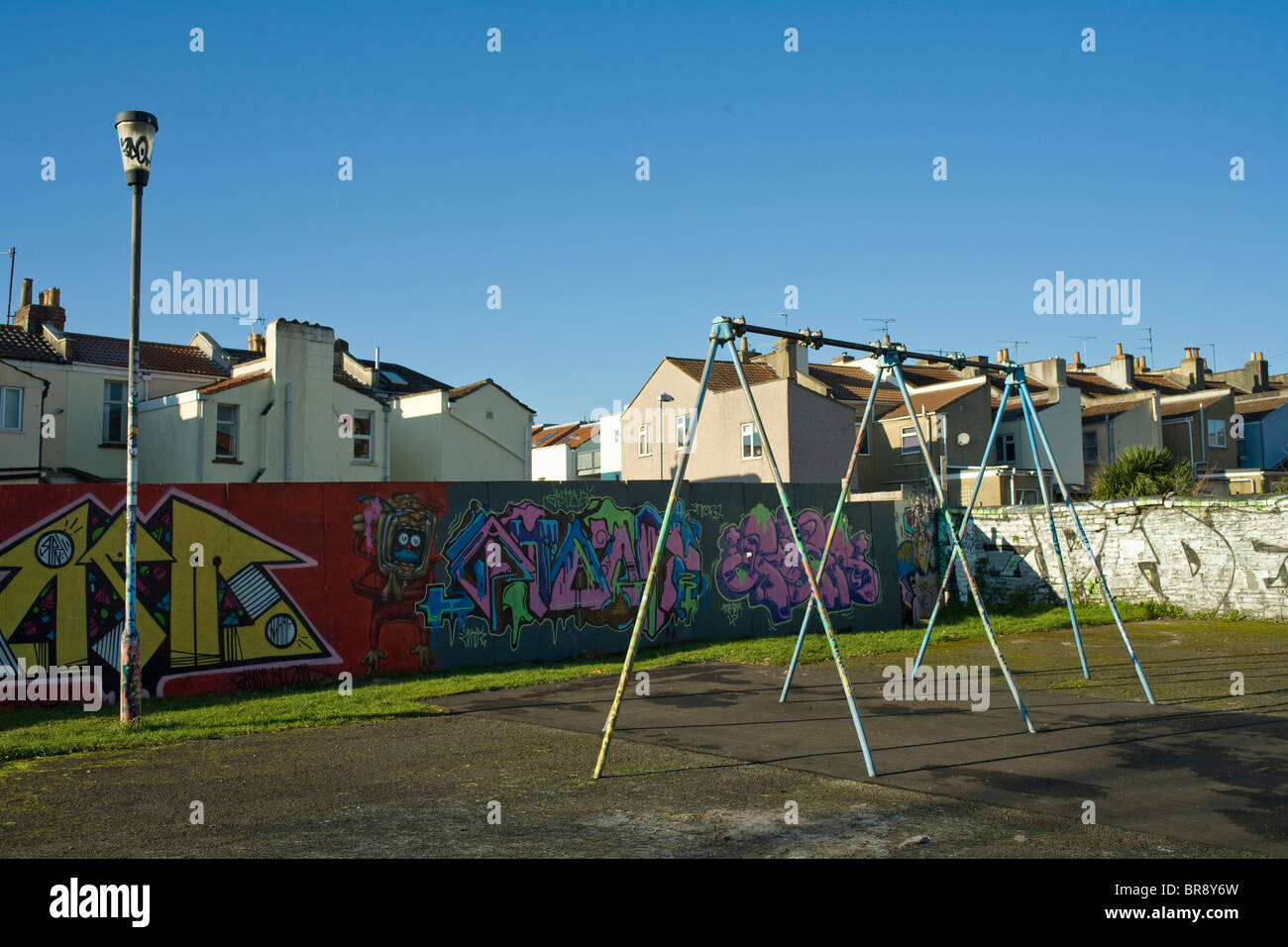 childrens swings in playground with graffiti Stock Photo - Alamy