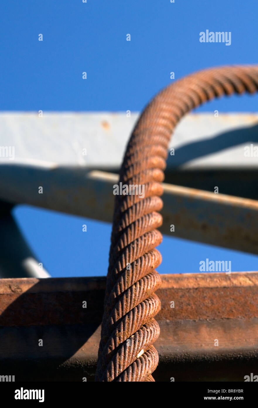 Bent rusted steel cable resting on a rusted metallic frame Stock Photo ...