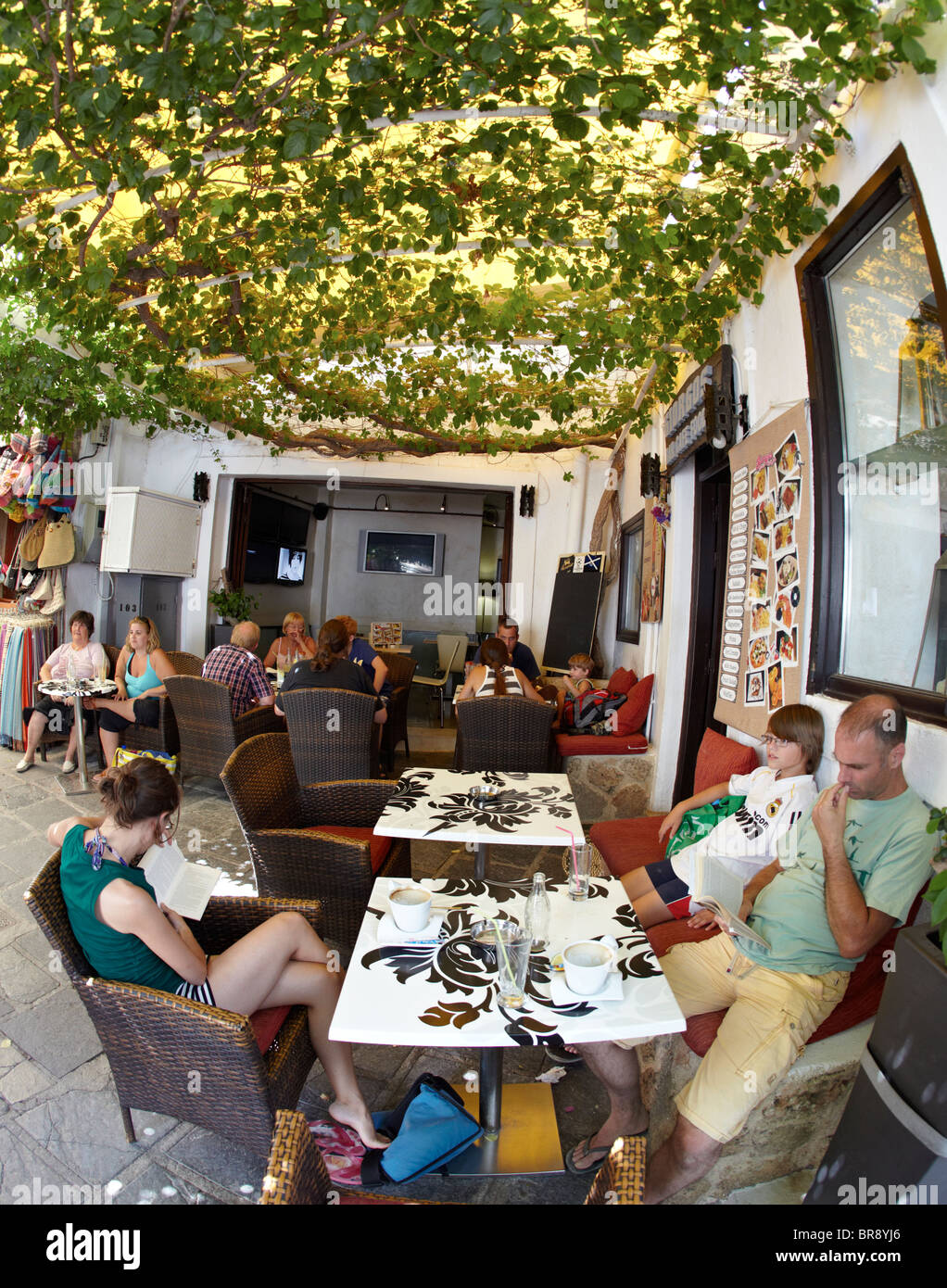 Tourists Sitting In A Bar Cafe In Lindos Rhodes Greek Islands Greece ...