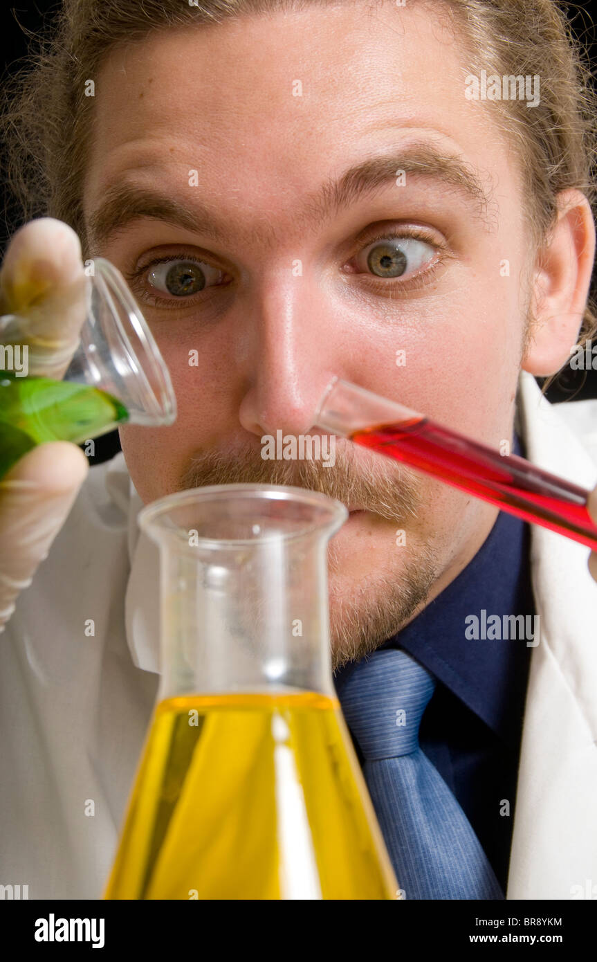 Scientist pouring chemicals in a laboratory Stock Photo - Alamy