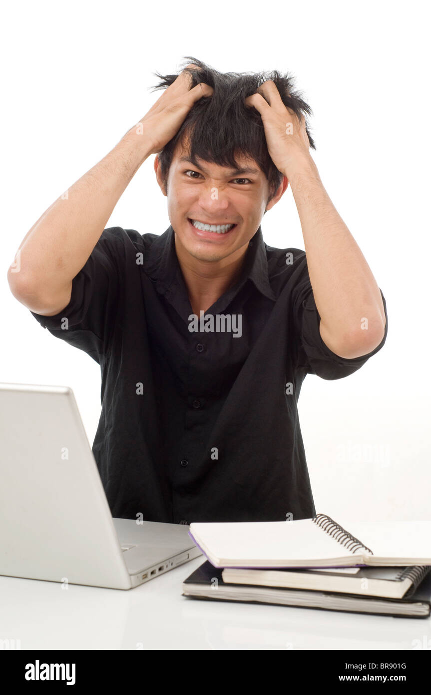 Young Asian male student doing homework Stock Photo - Alamy