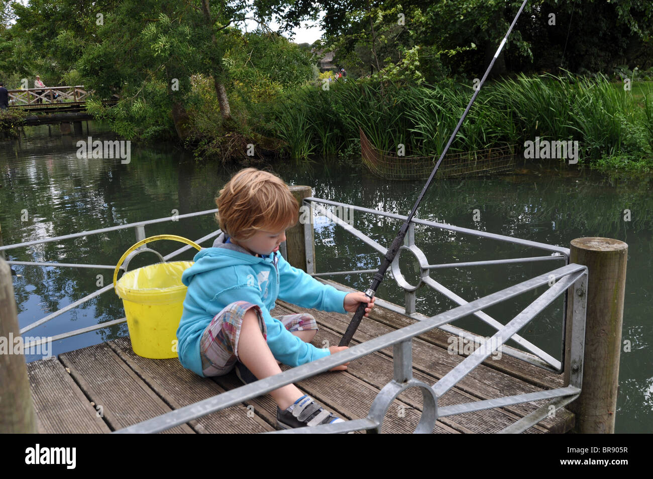 Boy Fishing at Bibury Trout Farm near Cirencester in the Cotswolds ...