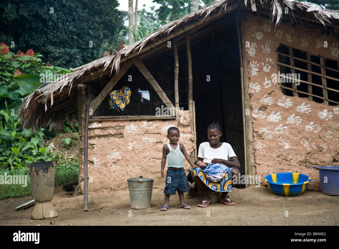 Mother and child at home in African village Stock Photo - Alamy