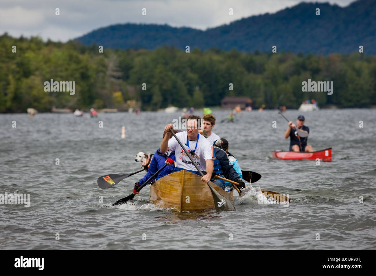 Paddlers with dog cross Fulton Chain of Lakes at Inlet, New York ...