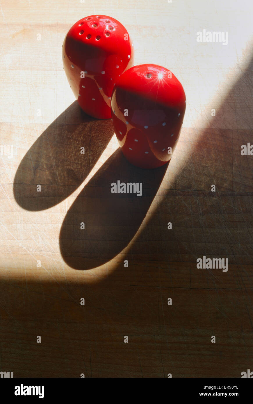A pair of salt and pepper pots, ceramic, pottery, bright red with white ...