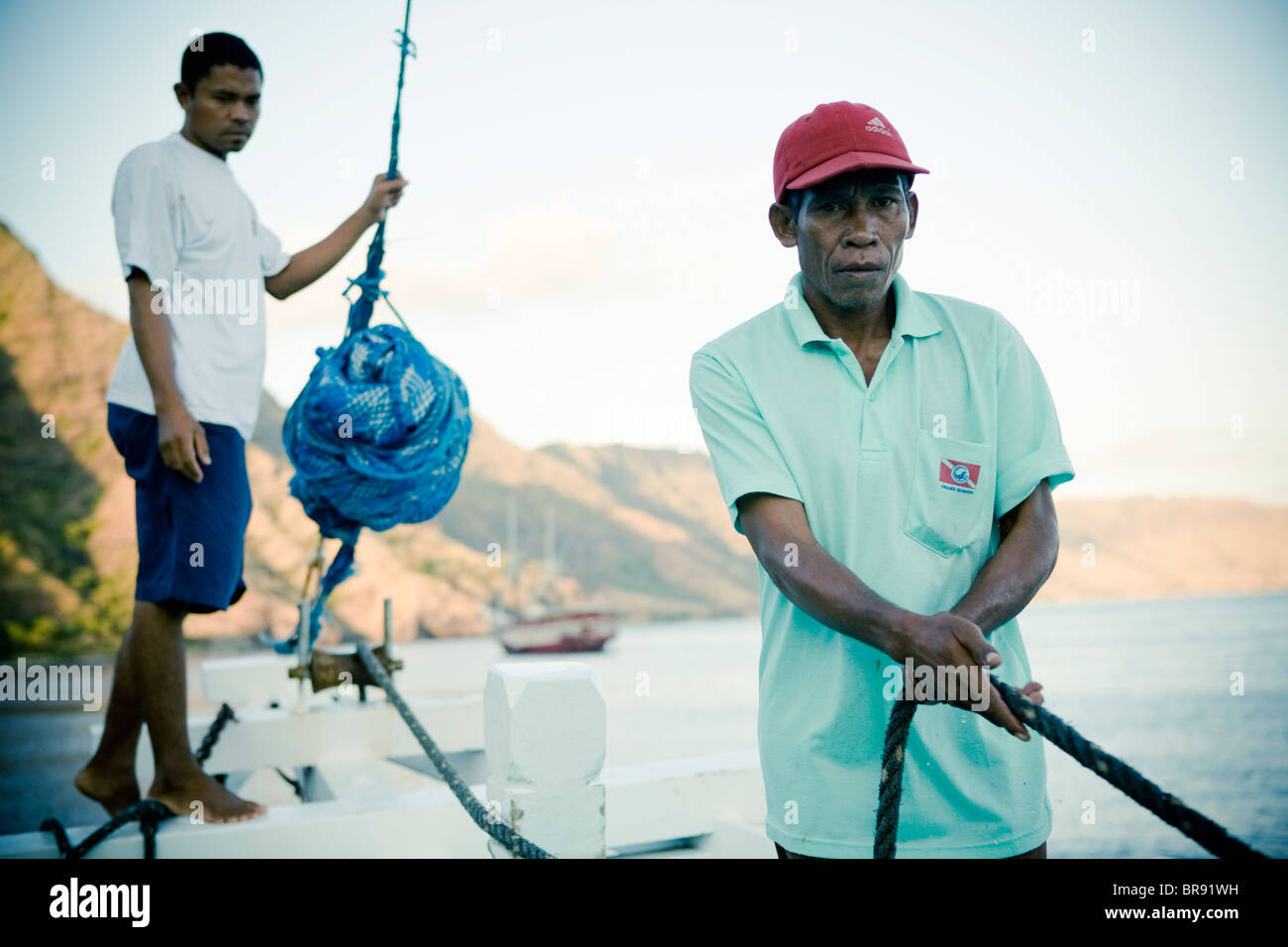 Two men working on a boat deck Stock Photo - Alamy