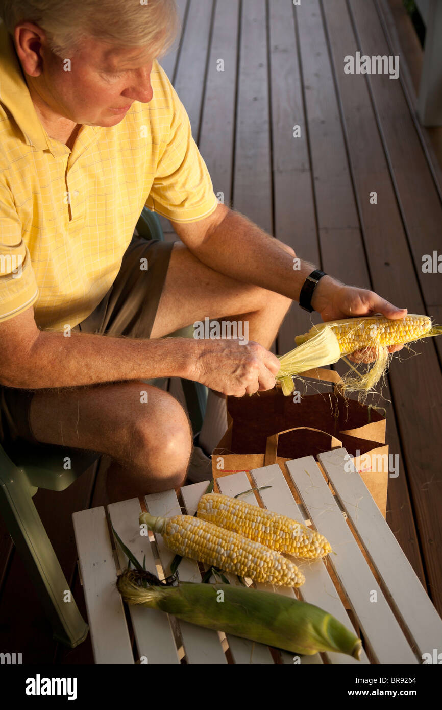 Shucking corn hi-res stock photography and images - Alamy