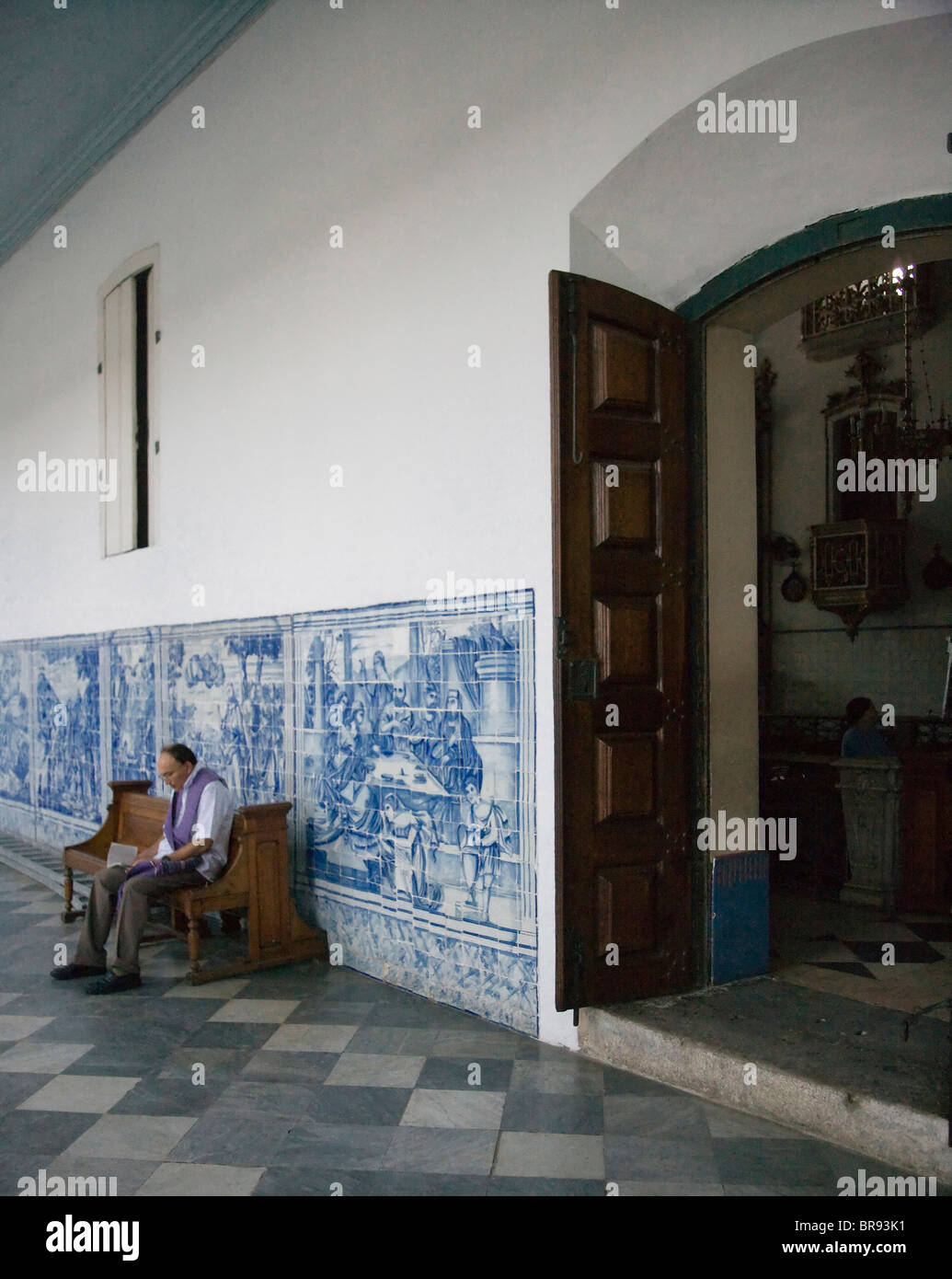 Brazil. Salvador Bahia. Man praying in the cloister of the Igreja de ...