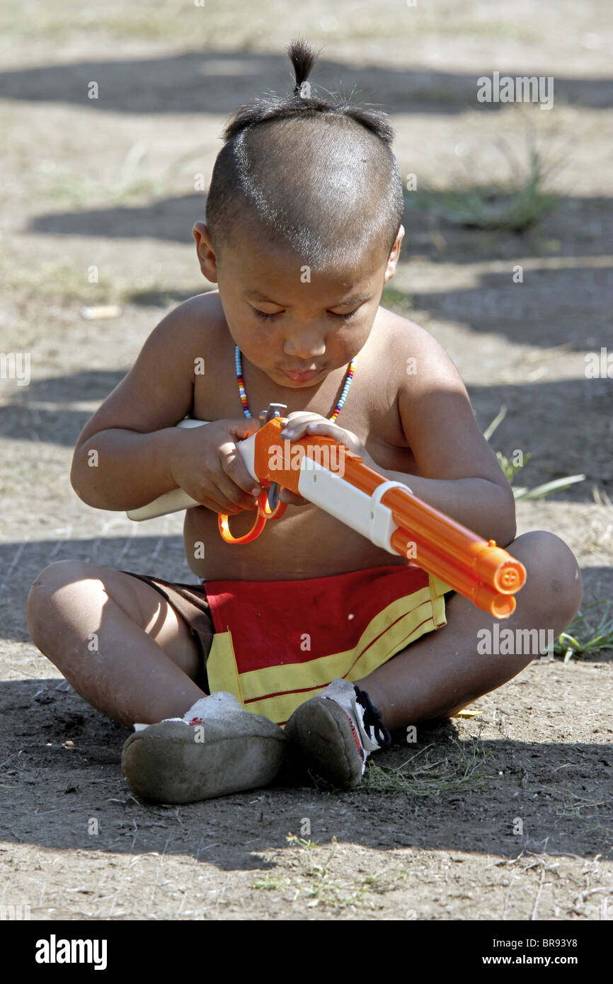 Cherokee, North Carolina - A young Cherokee boy plays with a toy rifle ...