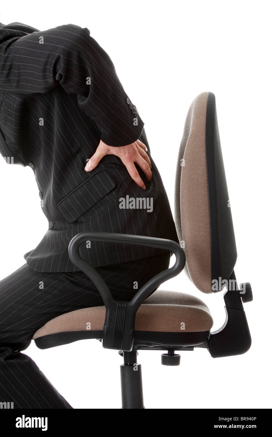 Businessman holding his hand to his aching back Stock Photo - Alamy