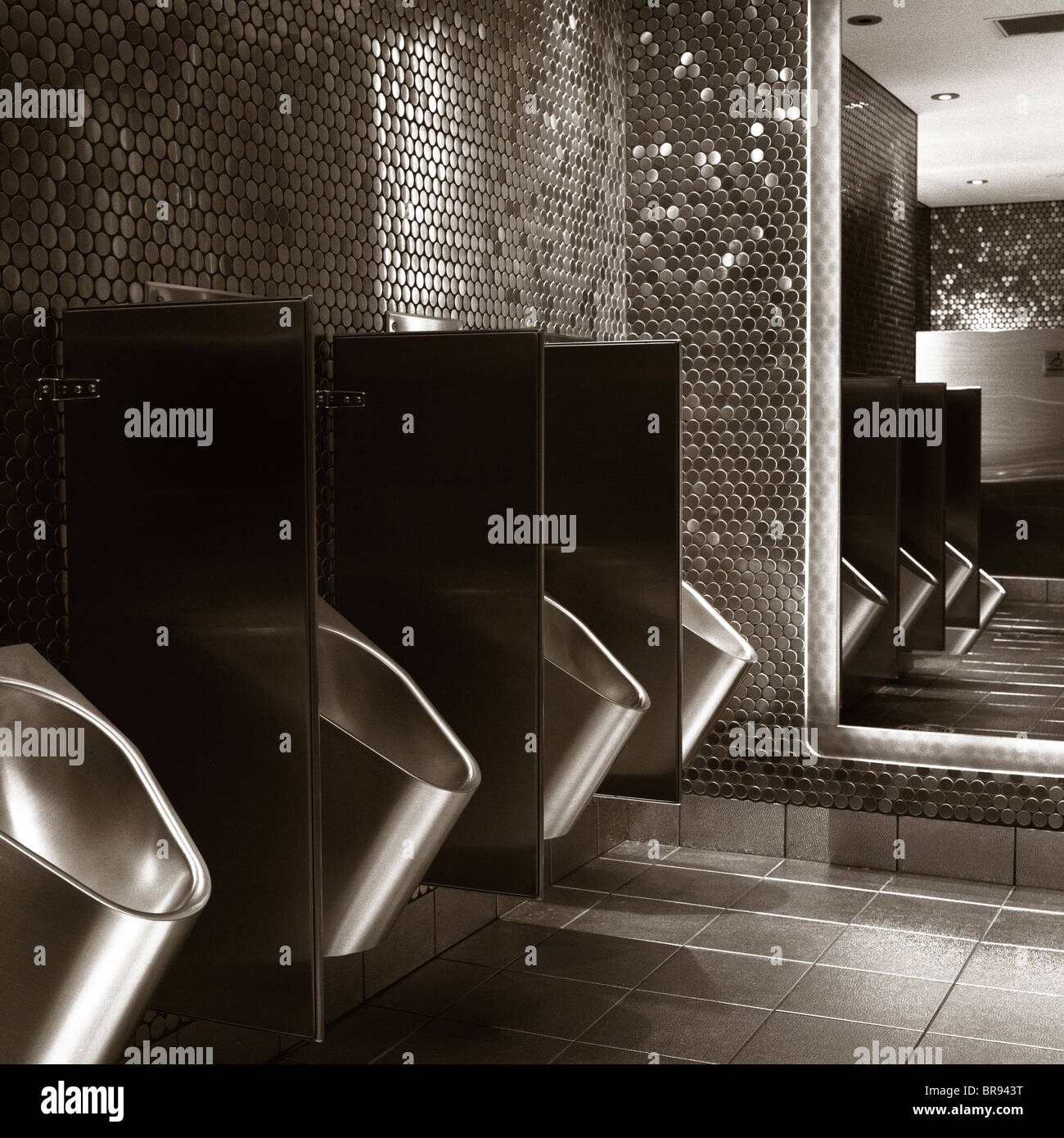 Four modern urinals in a hip upscale night club Stock Photo - Alamy