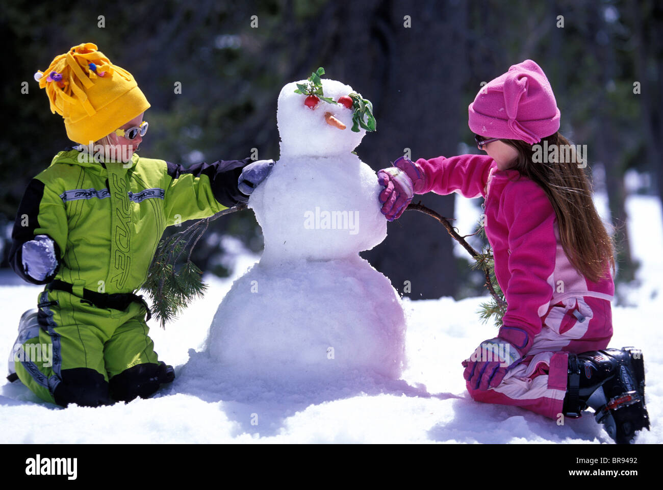 Kids making a snowman Stock Photo - Alamy