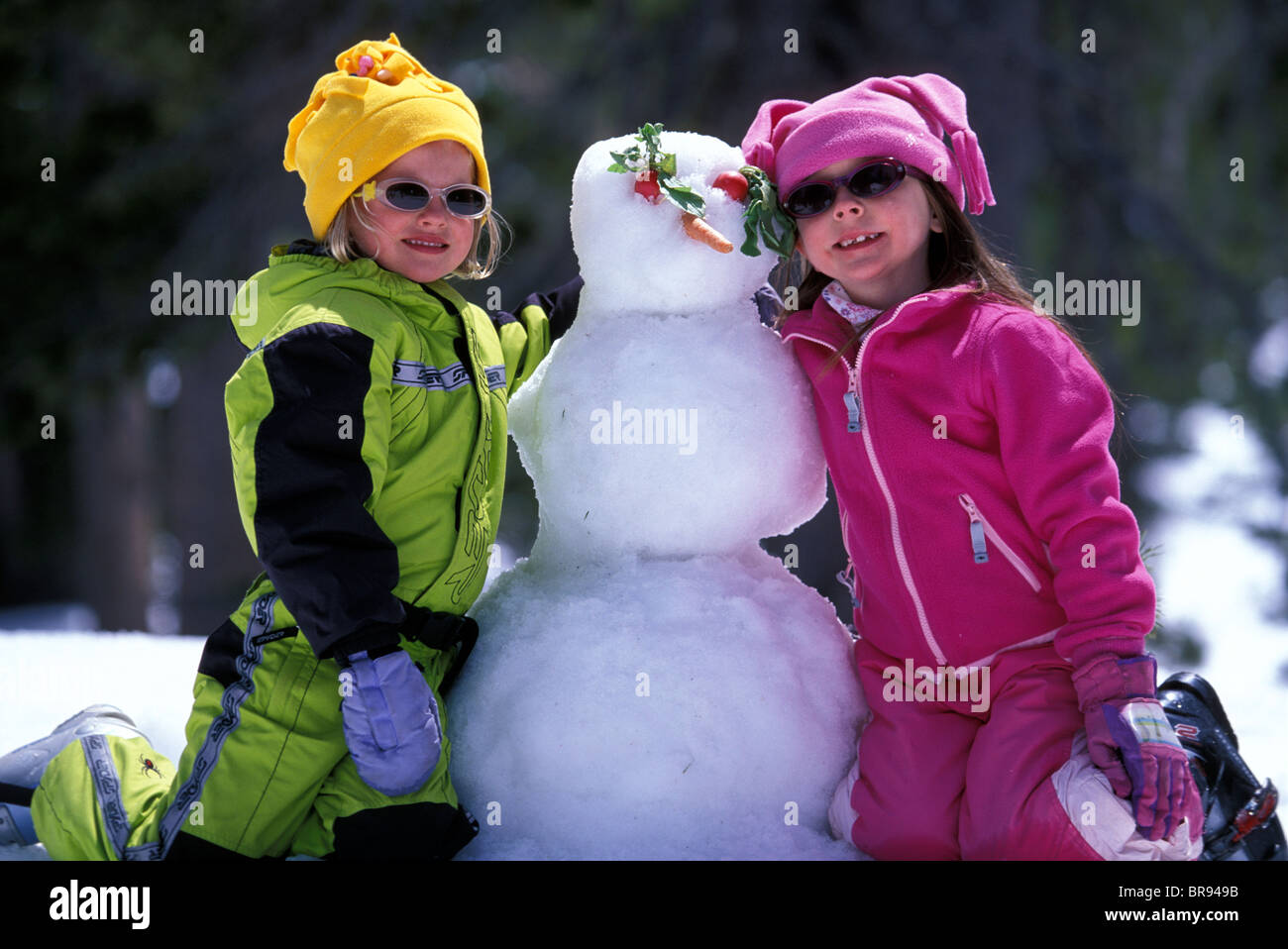 Kids making a snowman Stock Photo - Alamy