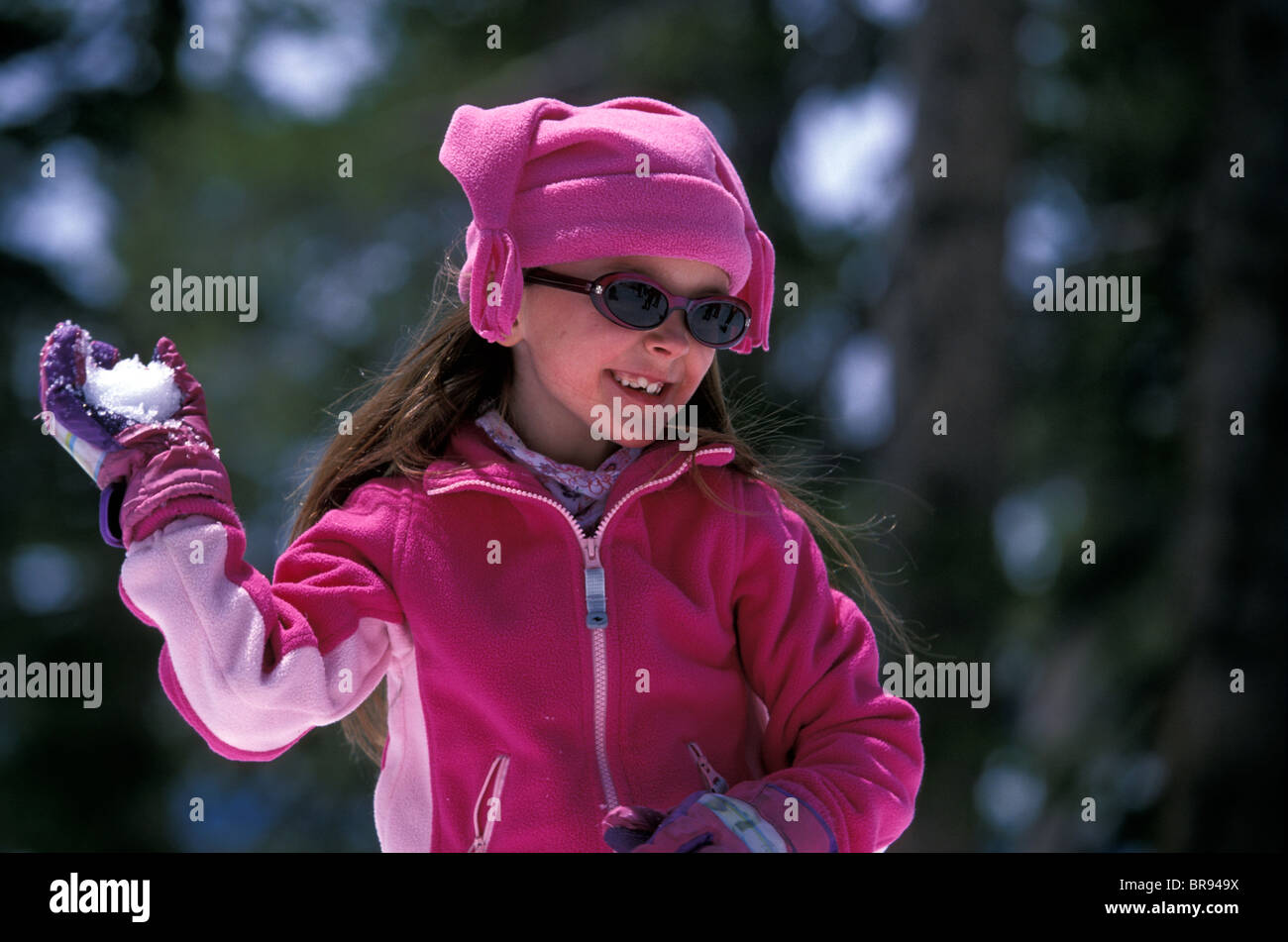 Little girl throwing a snowball Stock Photo - Alamy