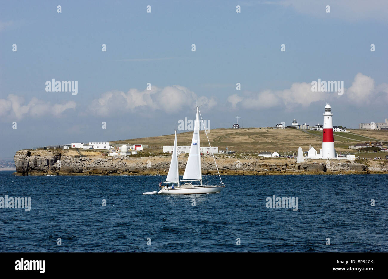 A yacht takes the inside passage northwards around Portland Bill on the ...