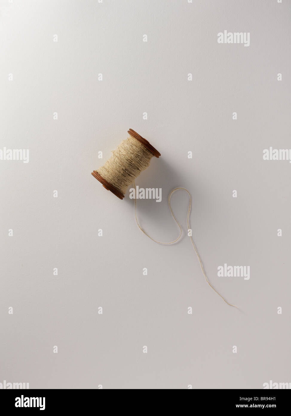 old bobbin and thread on a white background Stock Photo - Alamy